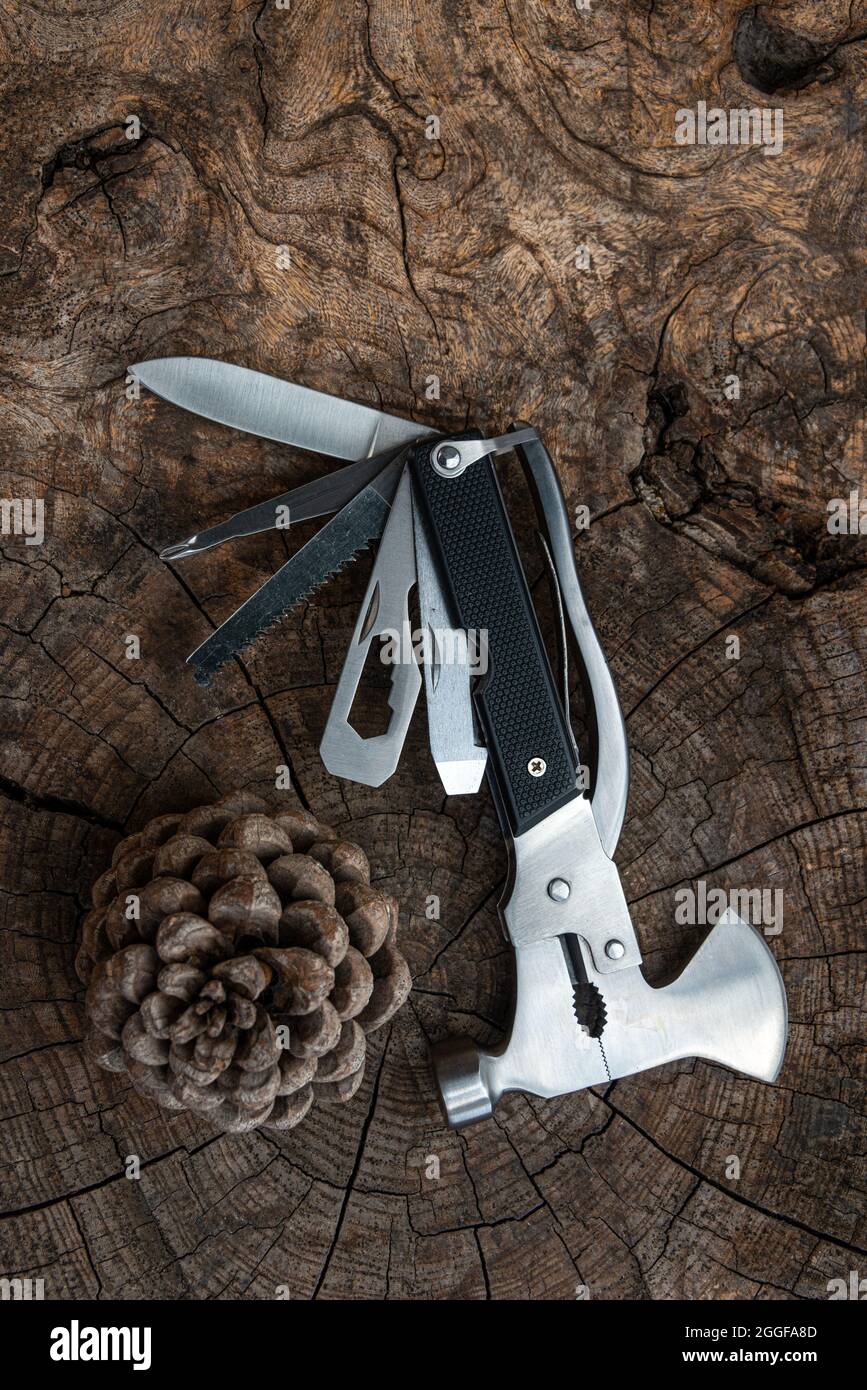 multi purpose tool on rustic wooden table ,camping and survival tools ...