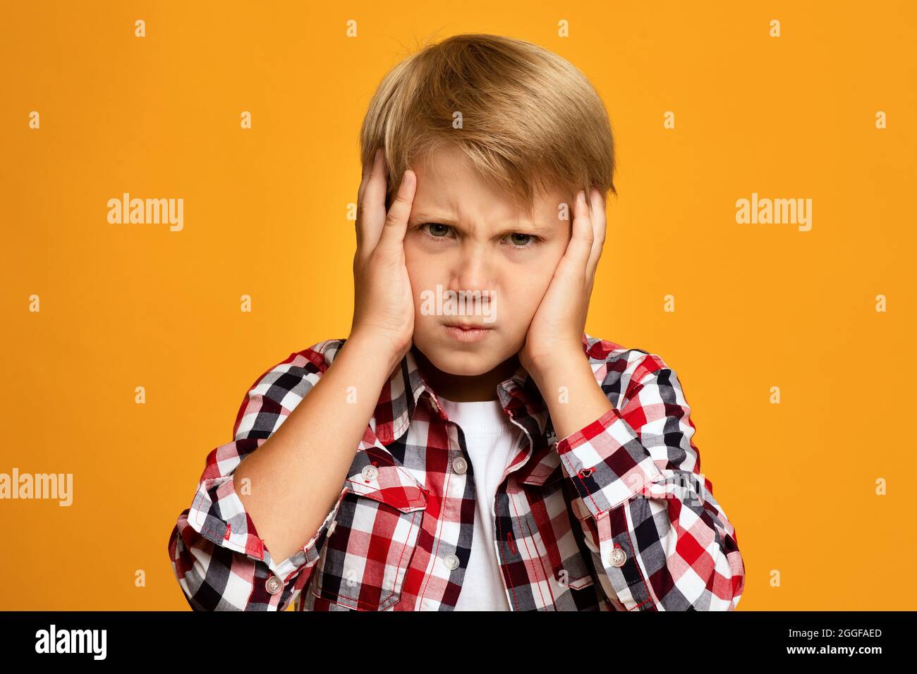 Sad upset angry european young blond boy in casual holding his head ...