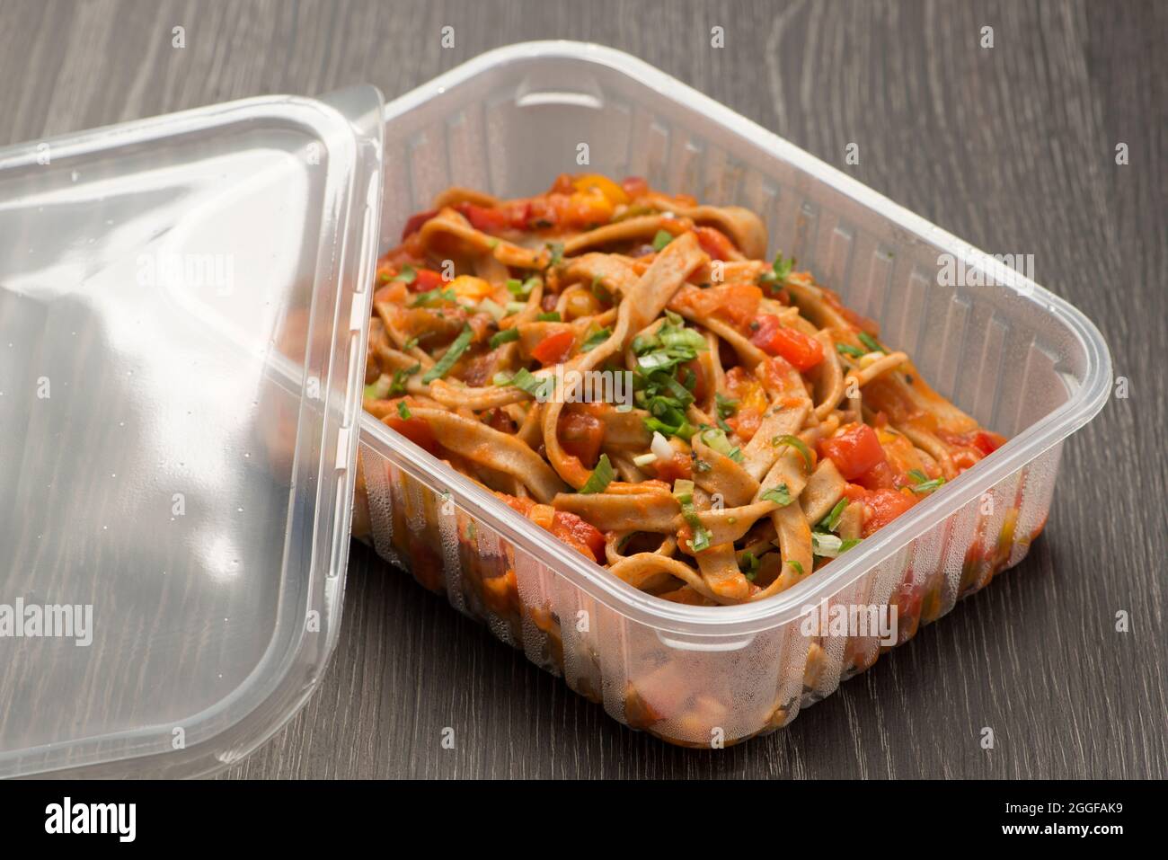 plastic lunch box with spaghetti with tomato sauce and chives Stock ...