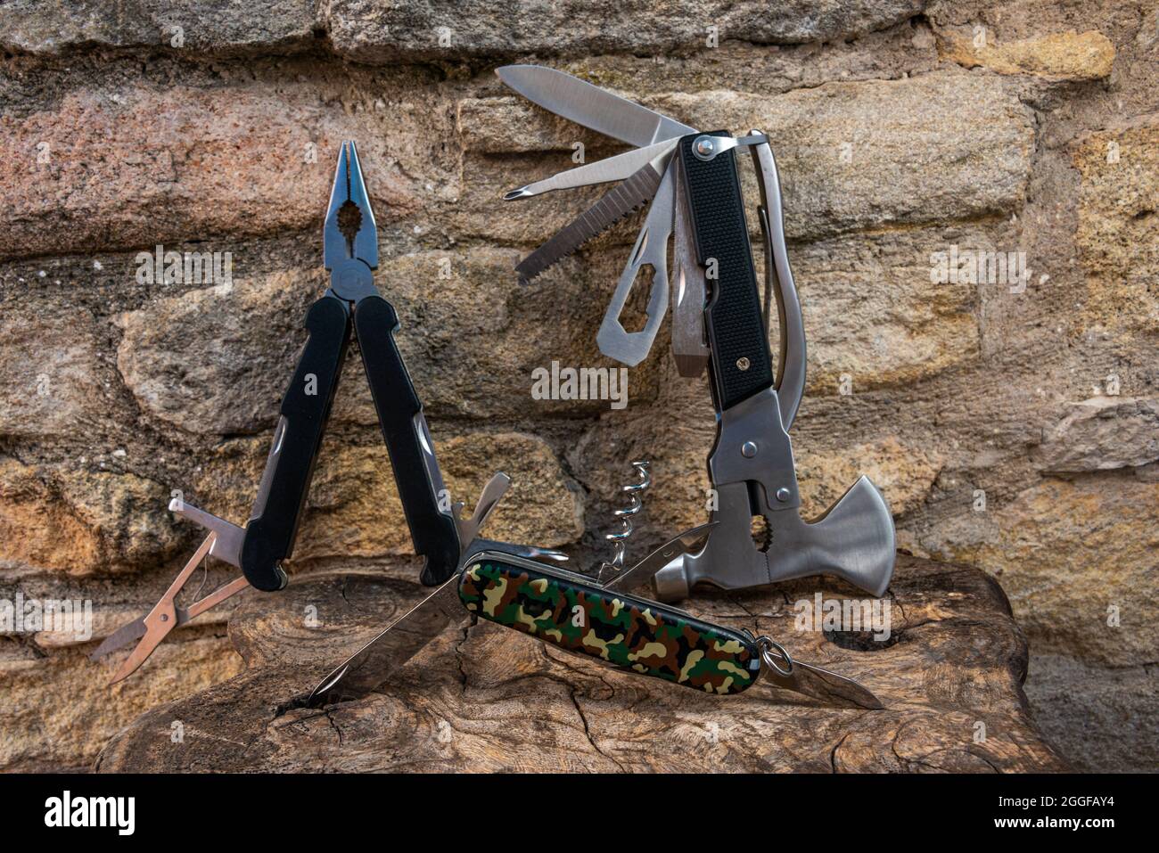 camping and survival multi purpose tools on rustic wooden table ...
