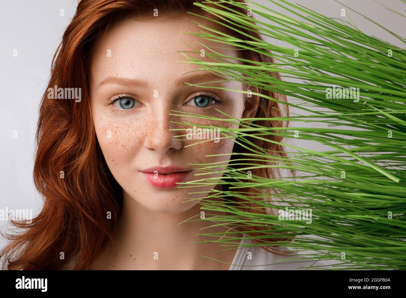 Ginger-Haired Millennial Lady Looking Through Green Grass Advertising ...