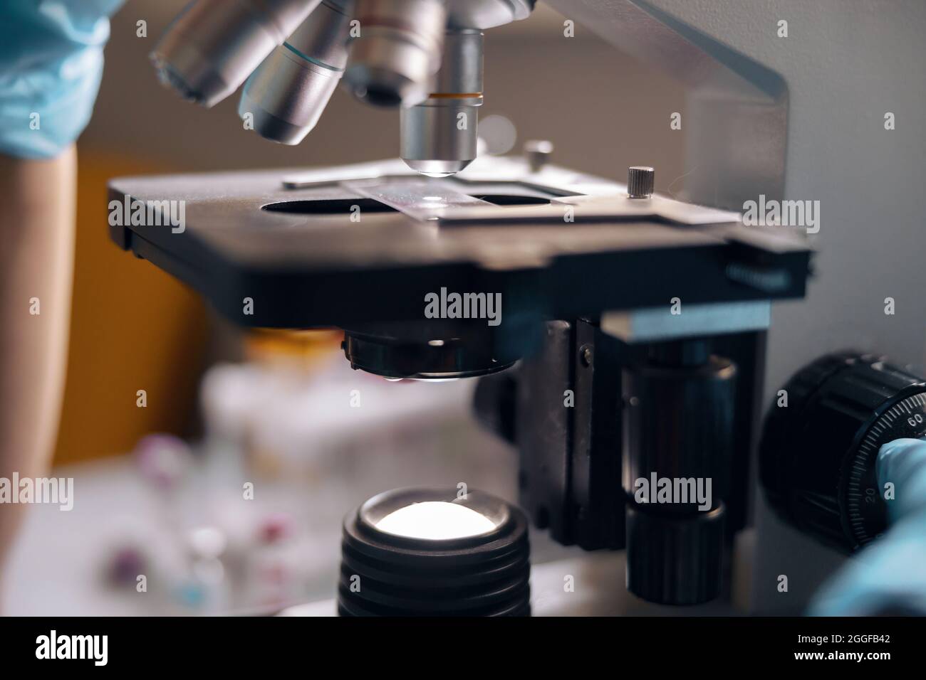 Modern microscope with material sample on slide in laboratory closeup ...