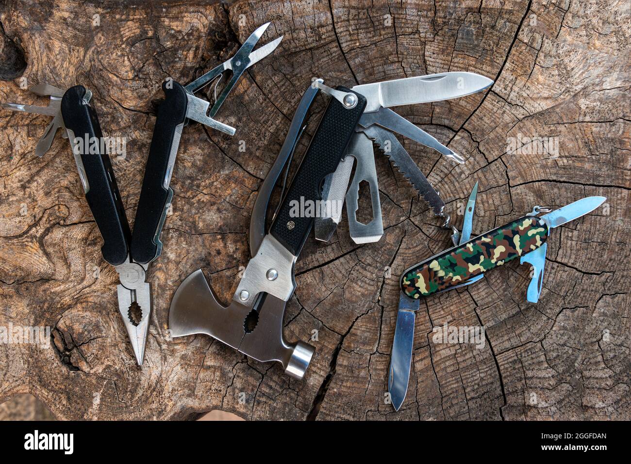 multi purpose tools on rustic wooden table ,camping and survival tools ...