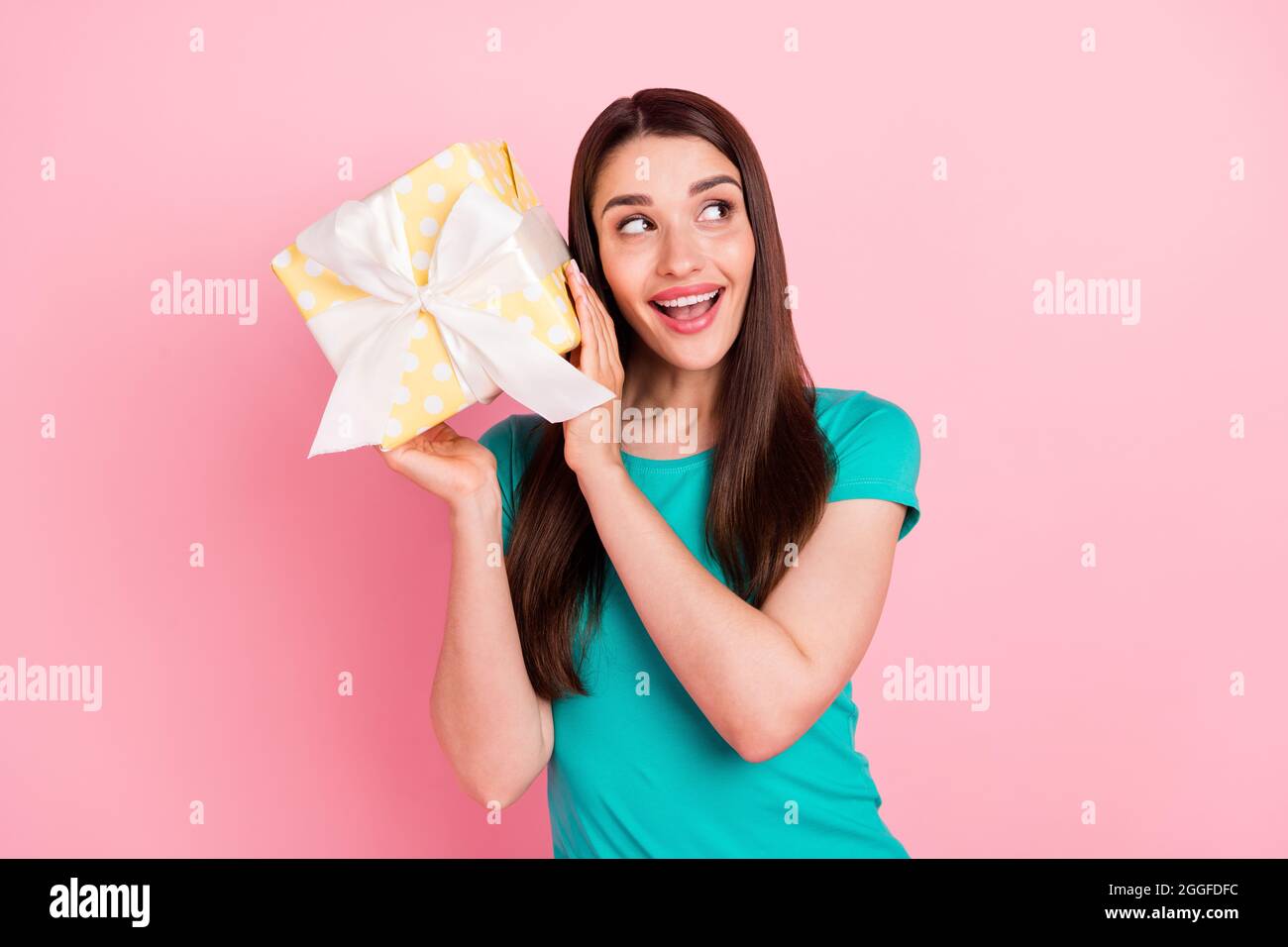 Photo of young excited woman happy positive smile shake present box ...