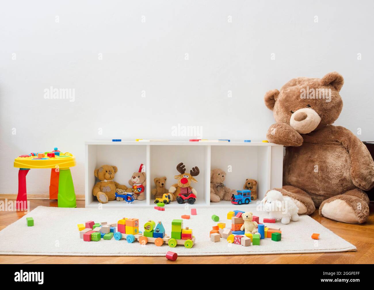 A child playroom with a giant teddy bear and many colorful toys ...
