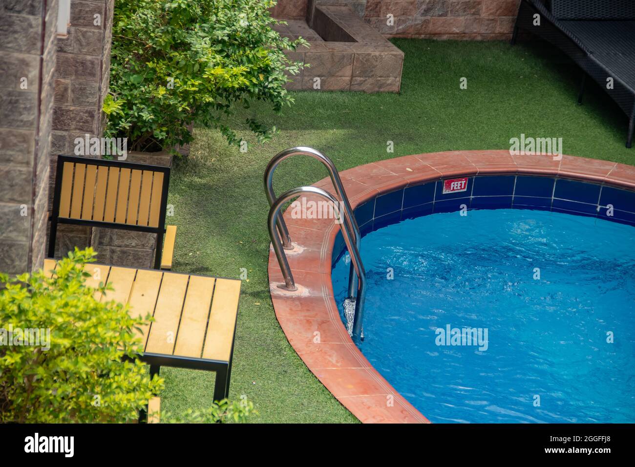 Small swimming pool in private luxury residence villa, with tables and ...