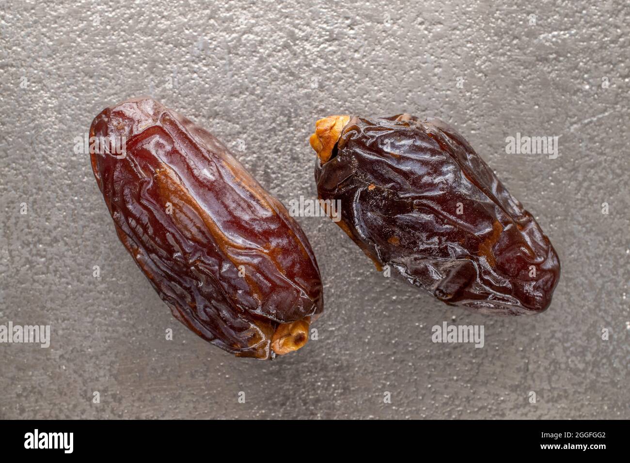 Two royal dates on a metal plate, close-up, top view Stock Photo - Alamy