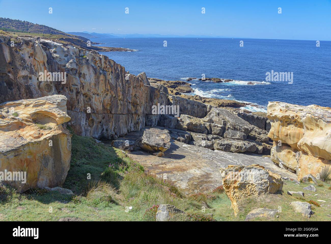 Colourful sandstone rock formations on the Cantabrian coastline. Mount ...