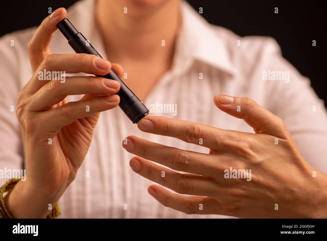 Diabetic patient checking blood glucose level using glucometer Stock ...