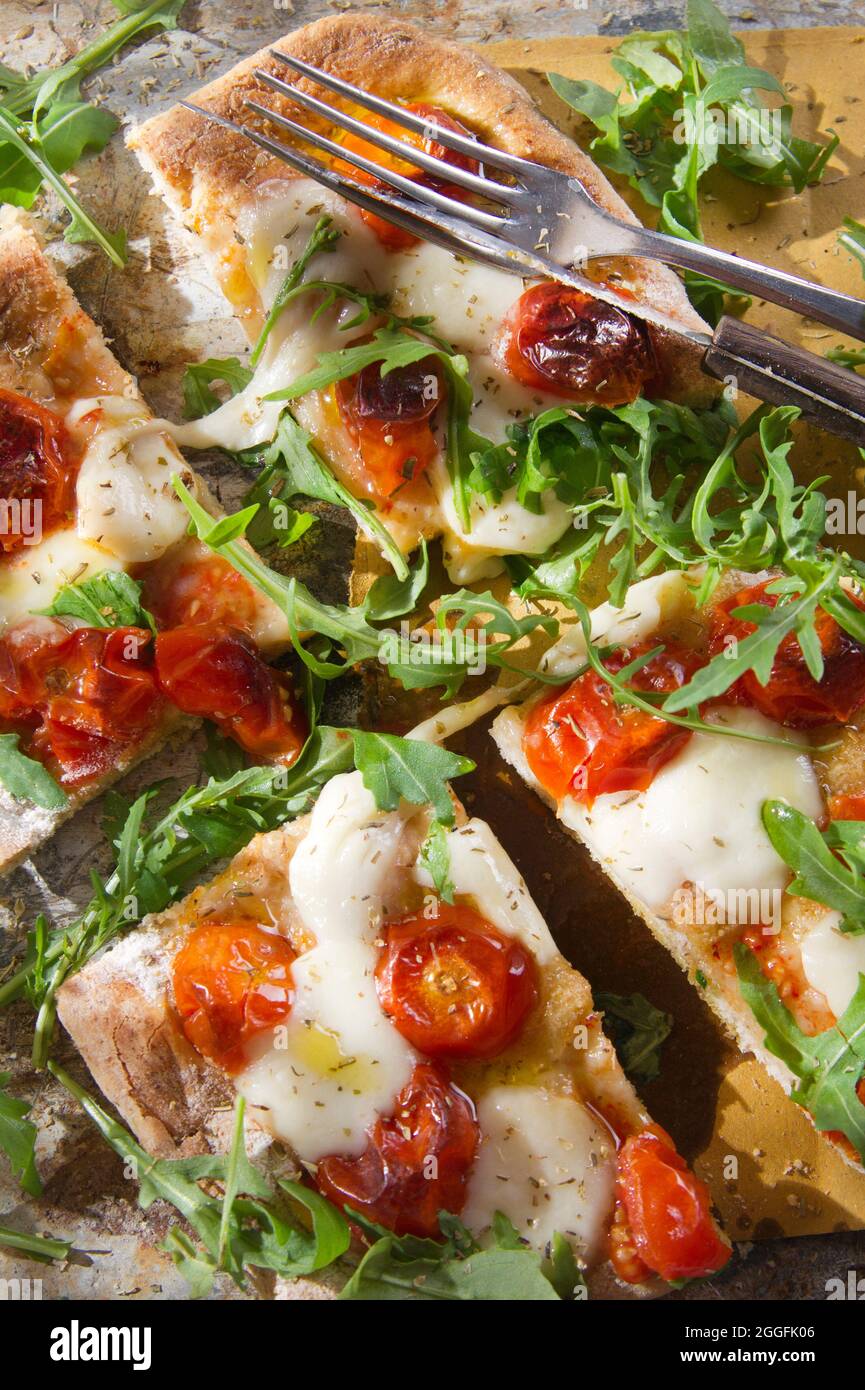 Tricolor pizza with tomato mozzarella and fresh arugula Stock Photo - Alamy
