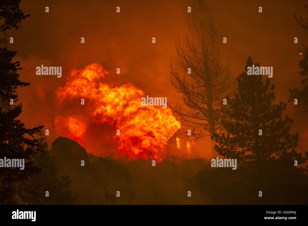 A vacation cabin burns as the Caldor Fire burns along highway 50 near ...