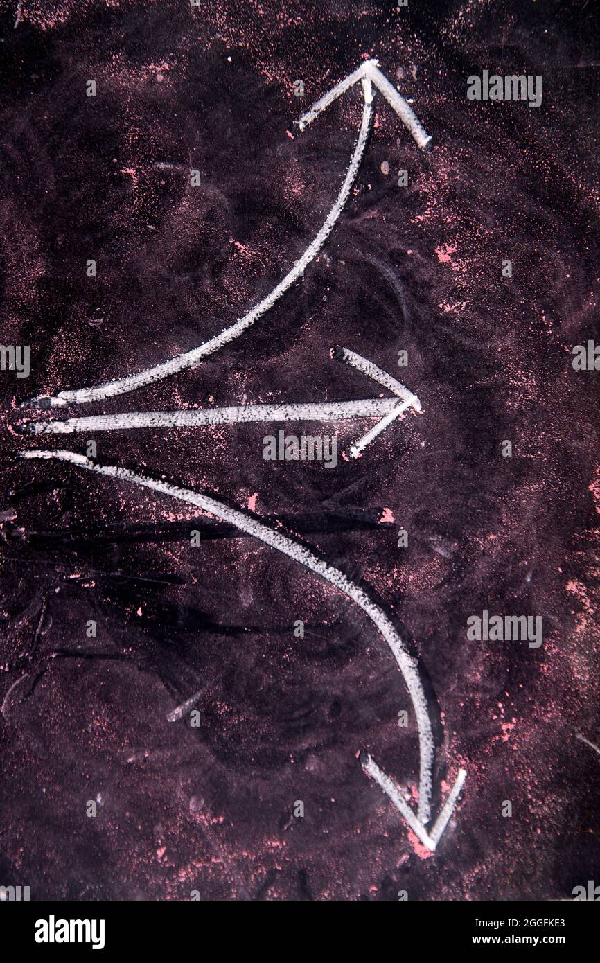 Graphical representation with chalk on blackboard three arrows showing ...