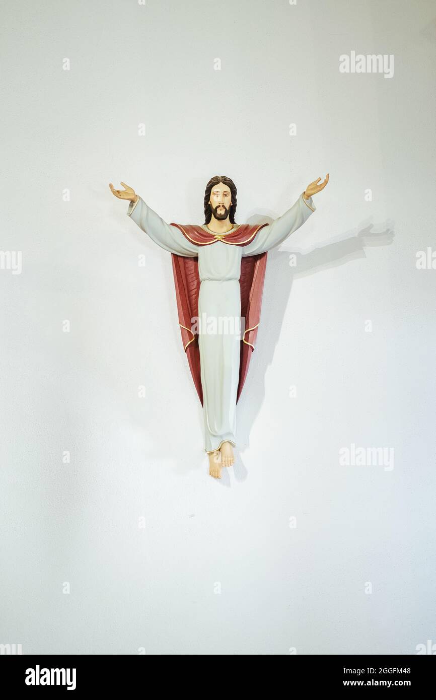 Figurine of Jesus Christ in the biblical robe with his hands raised up ...