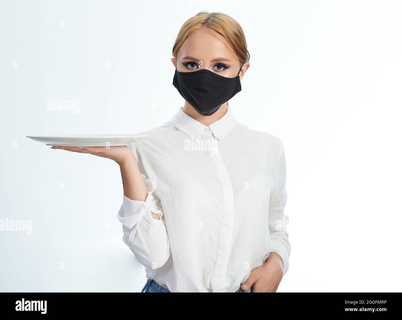 Pretty girl as waiter in face mask isolated on white studio background ...