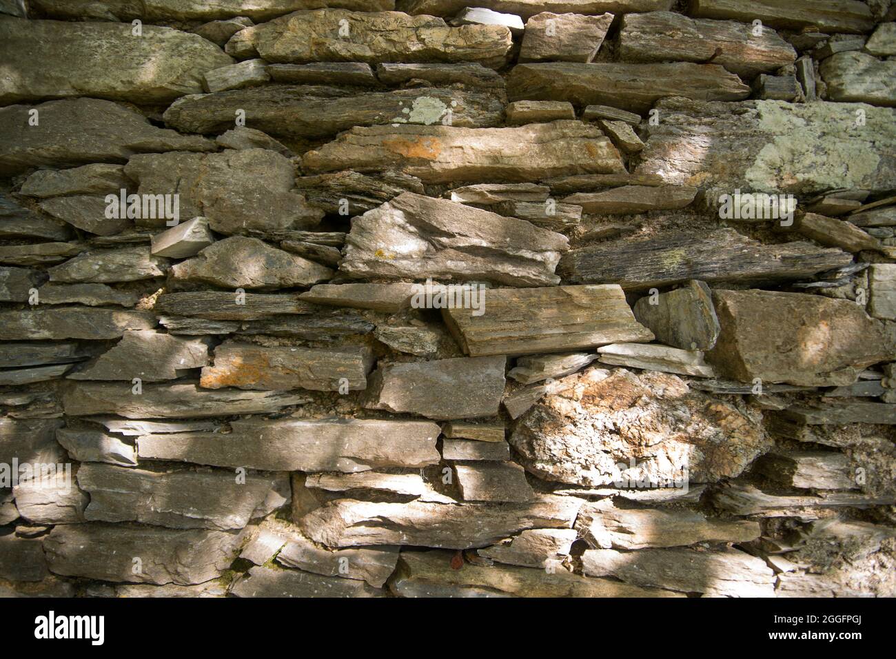 Old stone wall made with the technique of dry masonry Stock Photo - Alamy