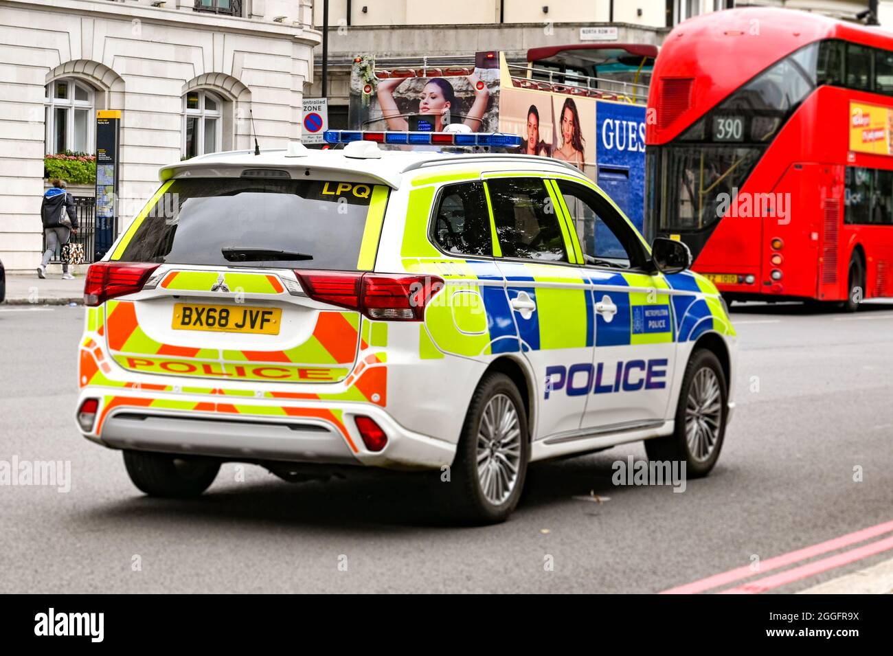 London, England - August 2021: Police patrol car driving down a street ...