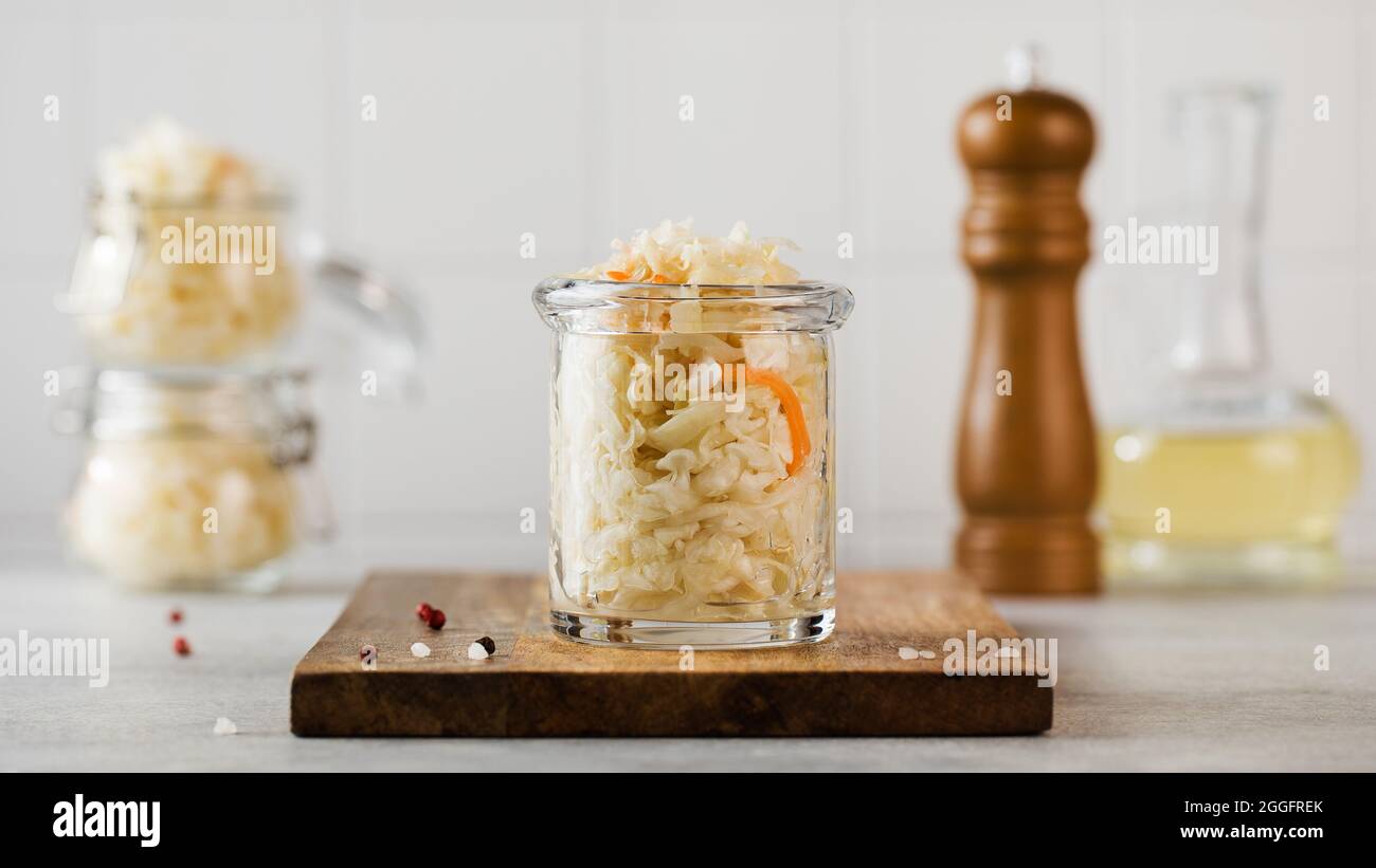 Sauerkraut in glass jars. Fermentation and canning of vegetables Stock ...