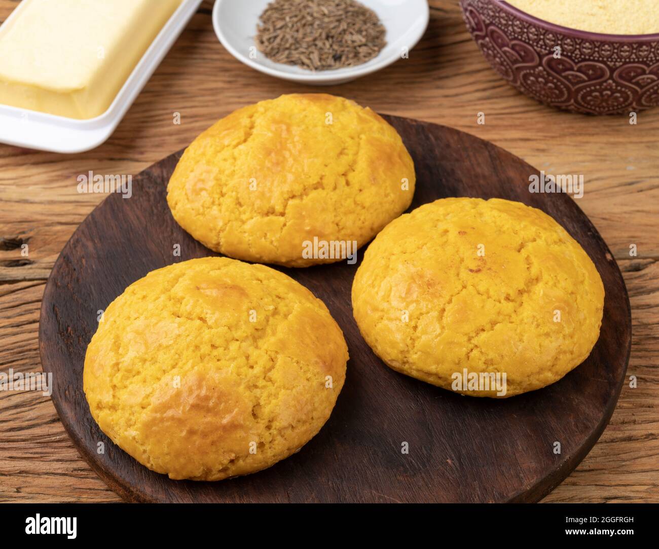 Broa, typical brazilian corn flour bread with ingredients. Butter ...