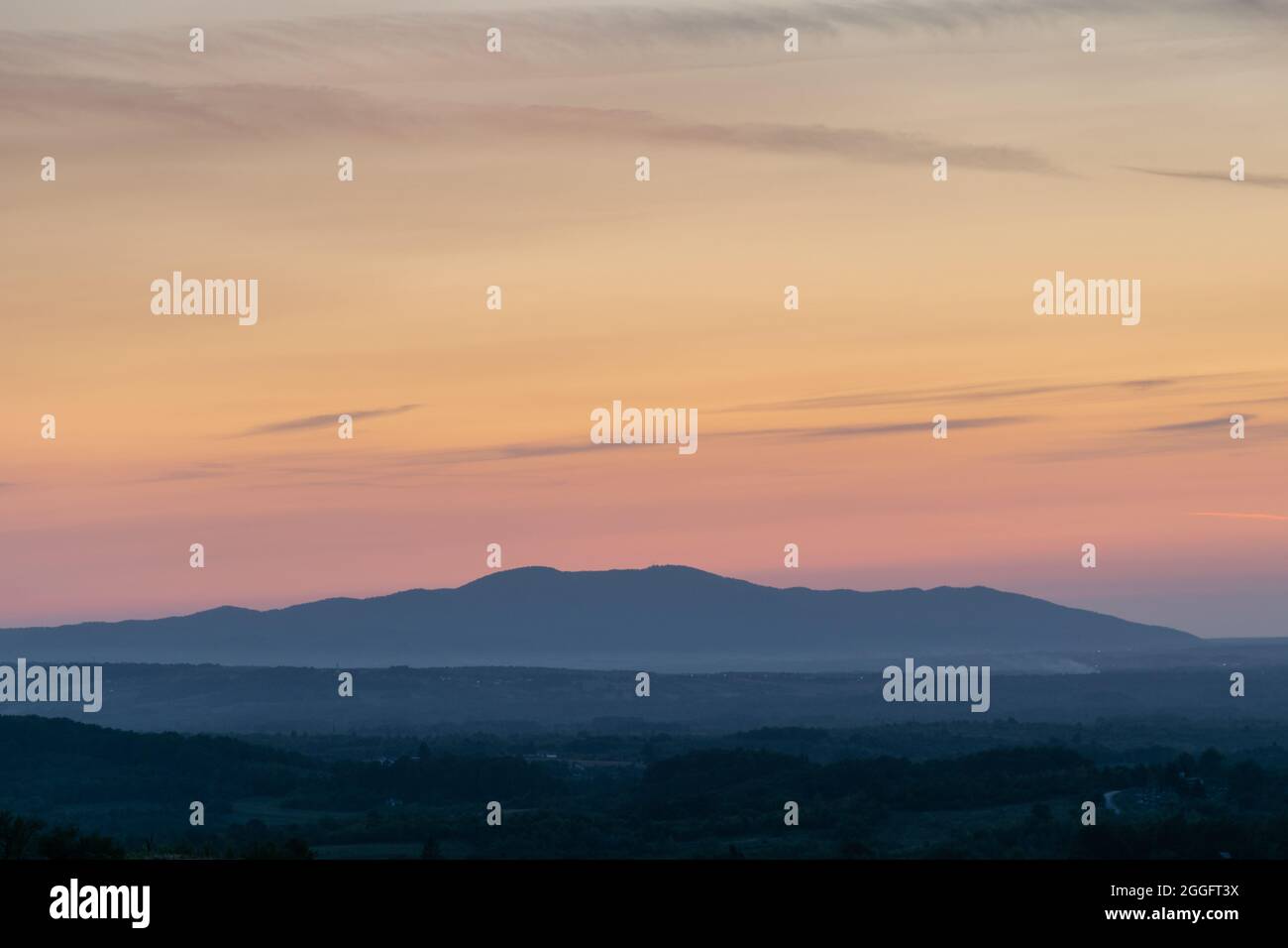 Mountain in haze and beautiful vivid colors in sky at dusk Stock Photo ...