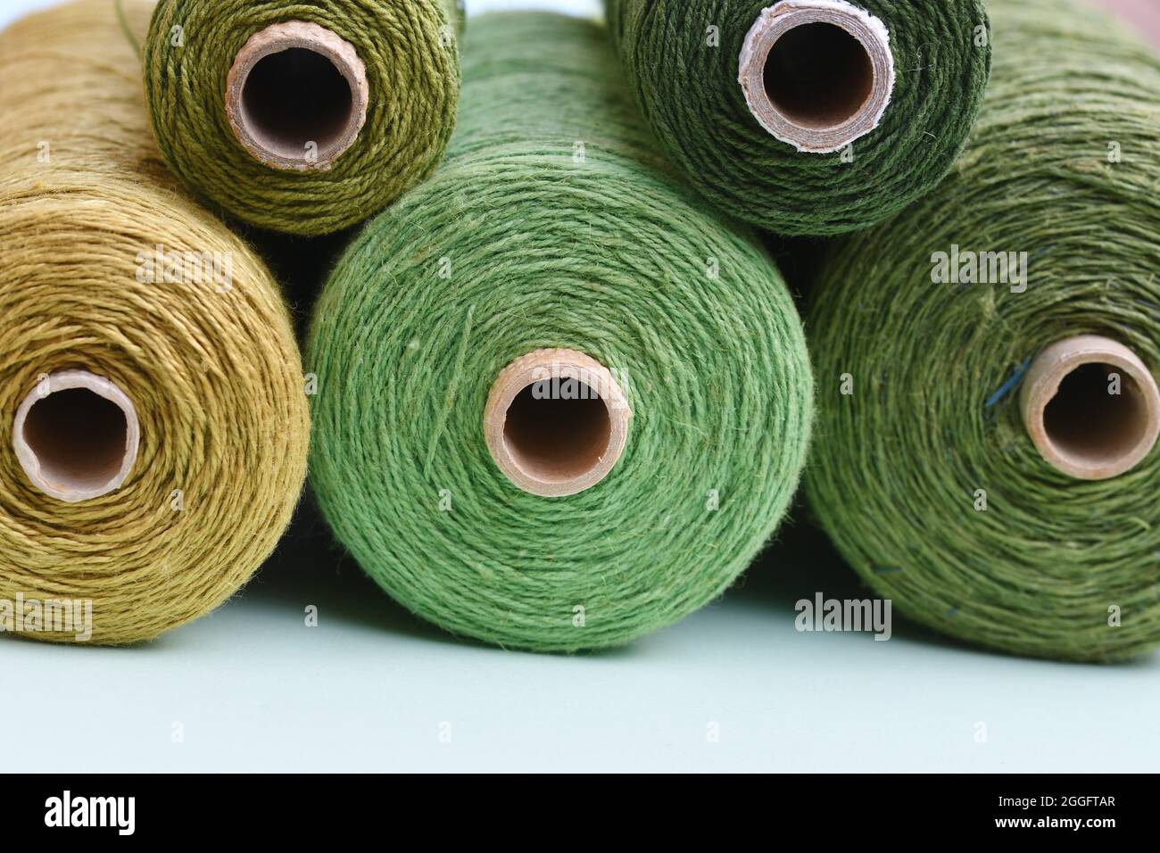 Closeup of green threads piled on each other Stock Photo - Alamy