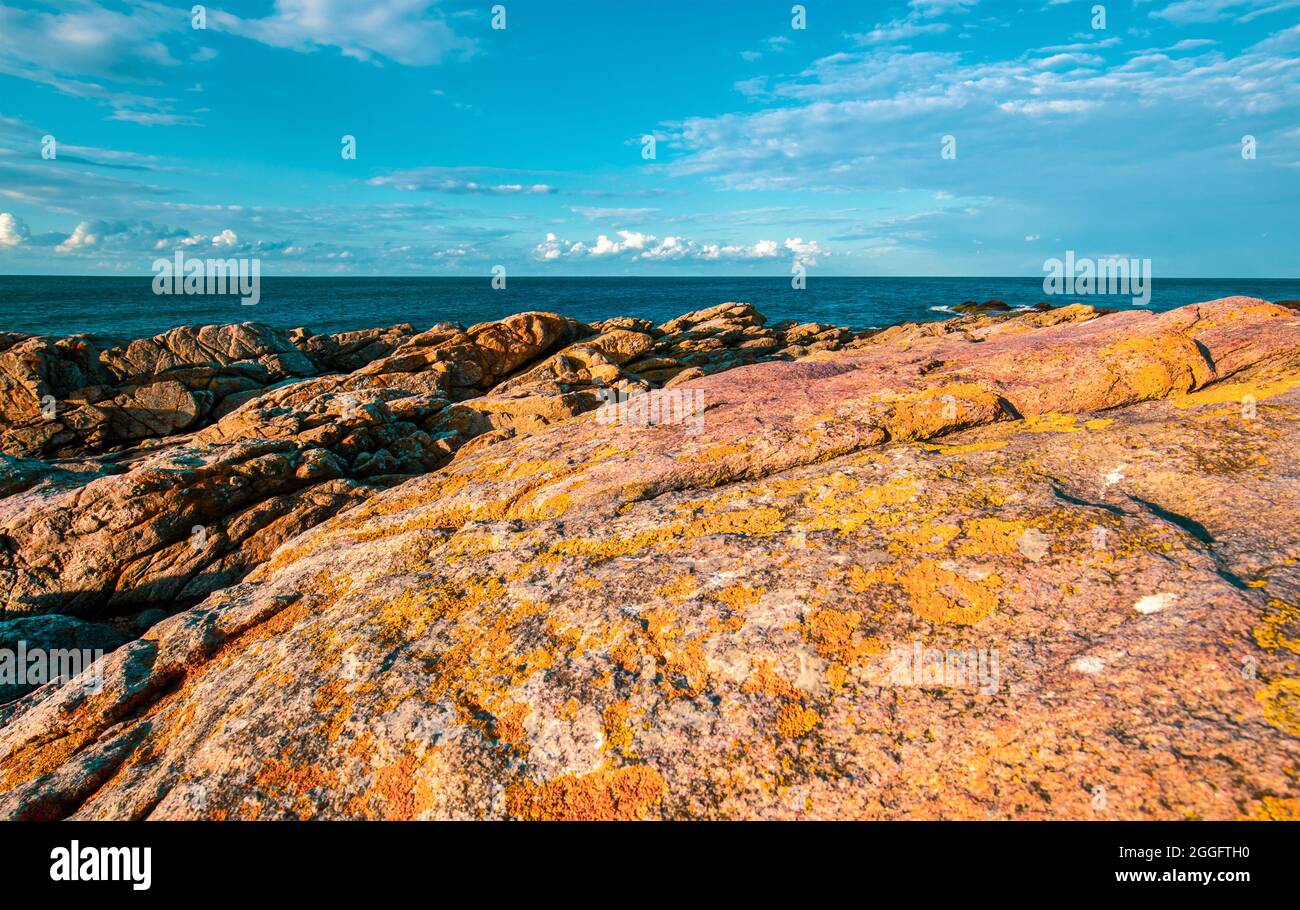 Colorful rock formation in the sea around picturesque small town ...