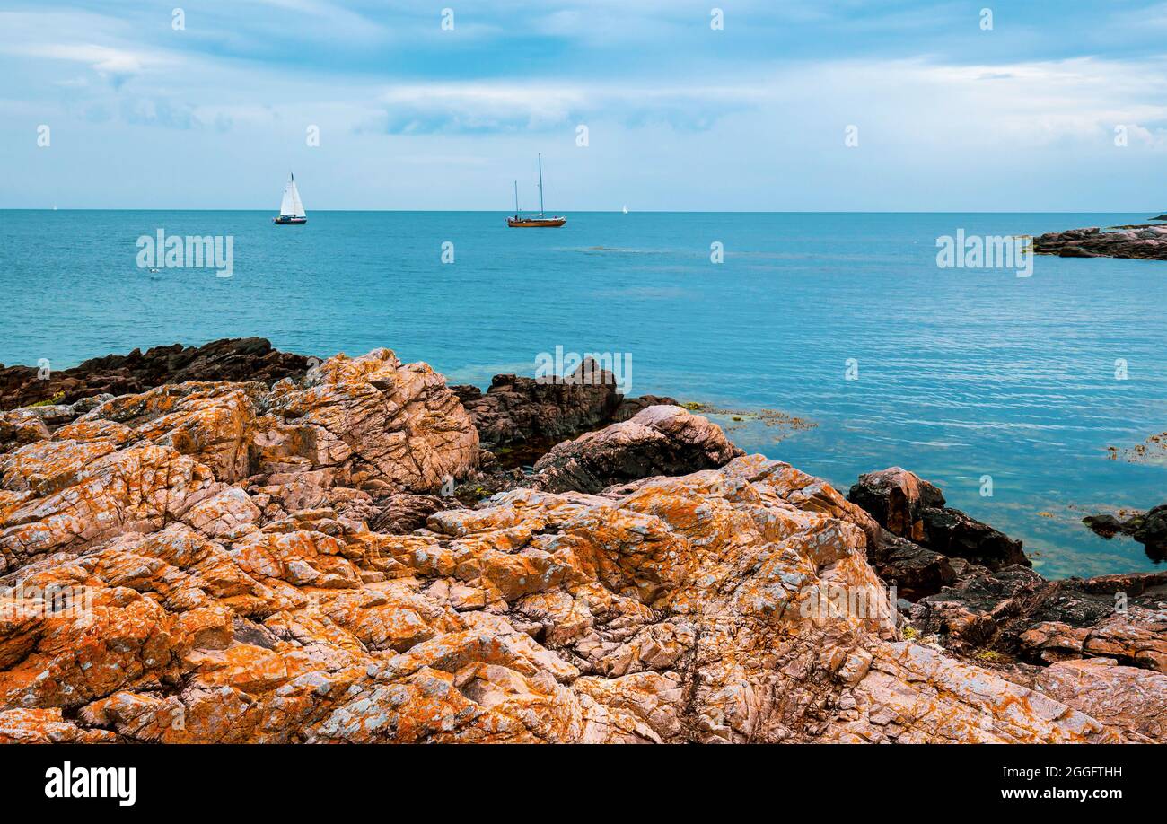 Colorful rock formation in the sea around picturesque small town ...