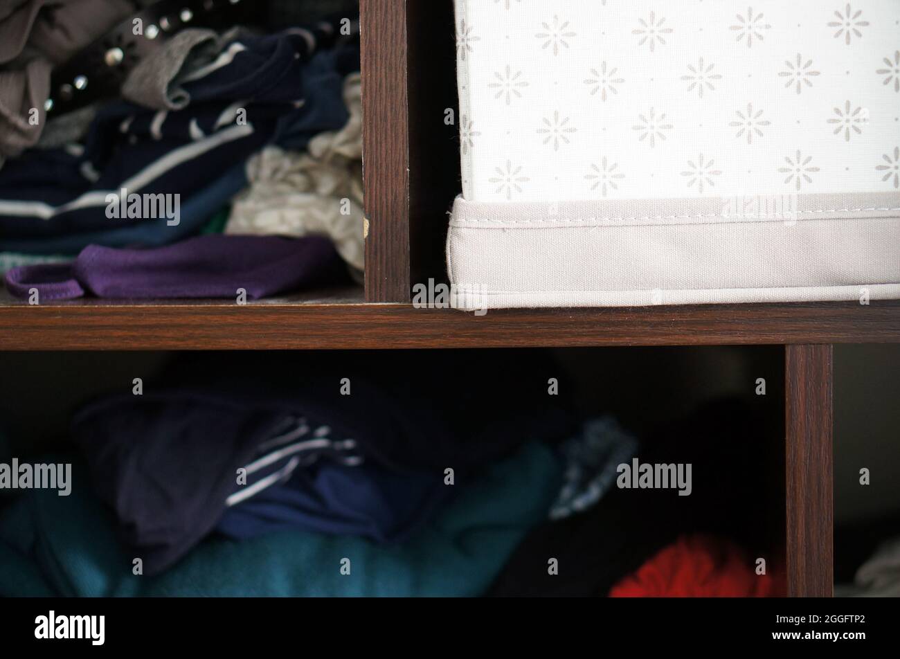 Wooden cabinet with disorganized clothes Stock Photo - Alamy