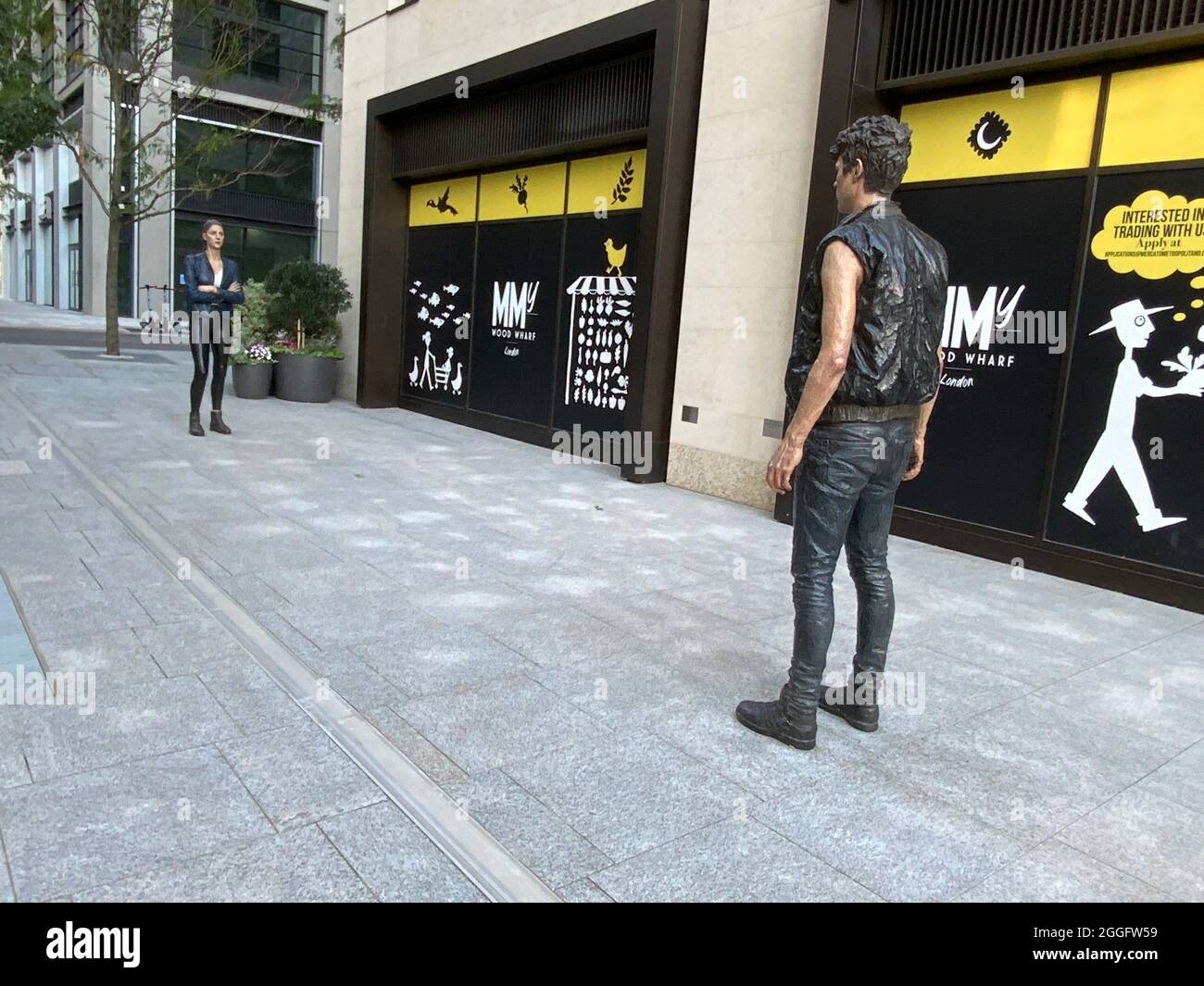 Tall statues of man and woman at Canary Wharf, London, United Kingdom ...