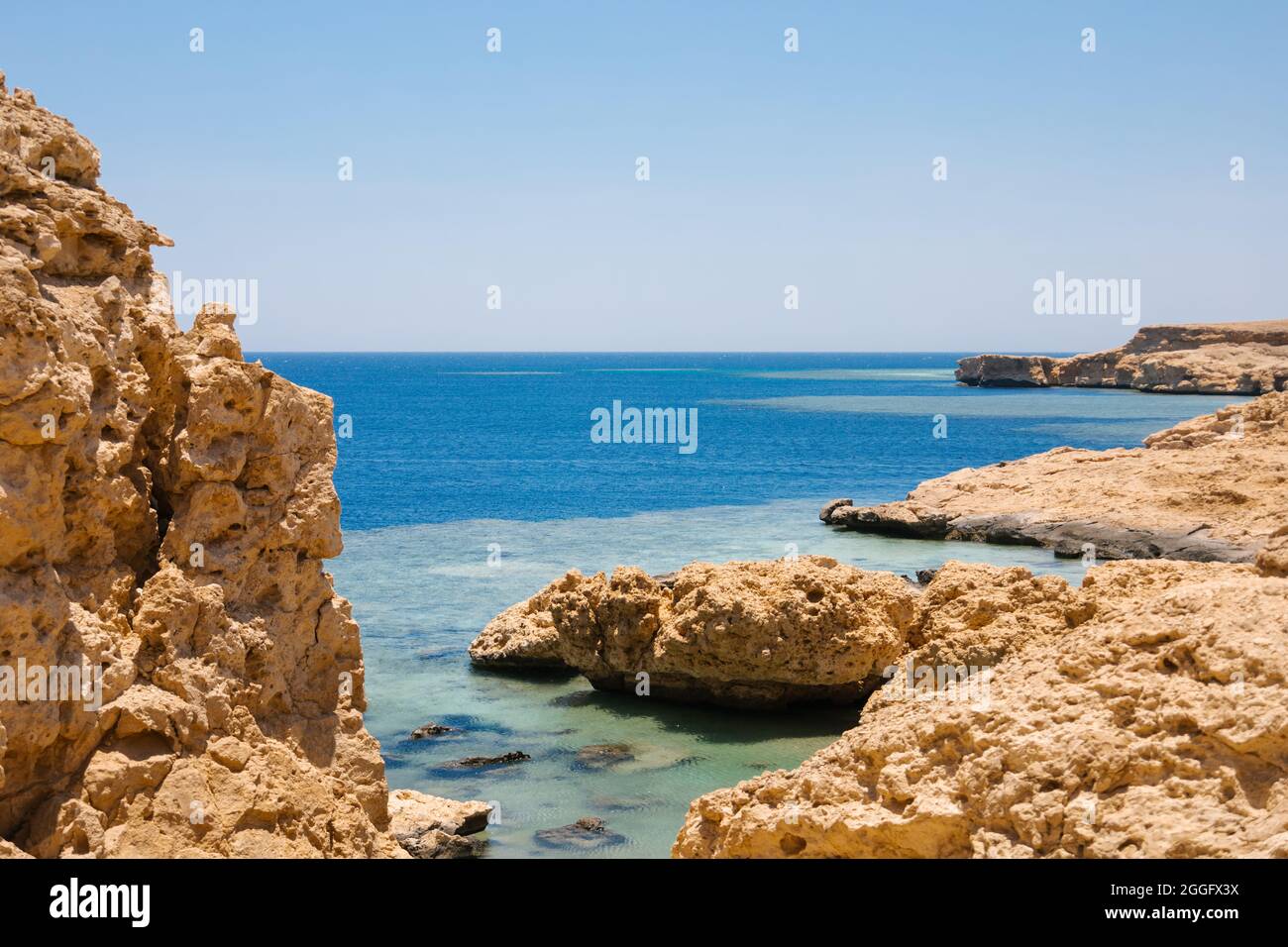 Sandy and rocky coast with blue color of water. Desolate beach on the ...