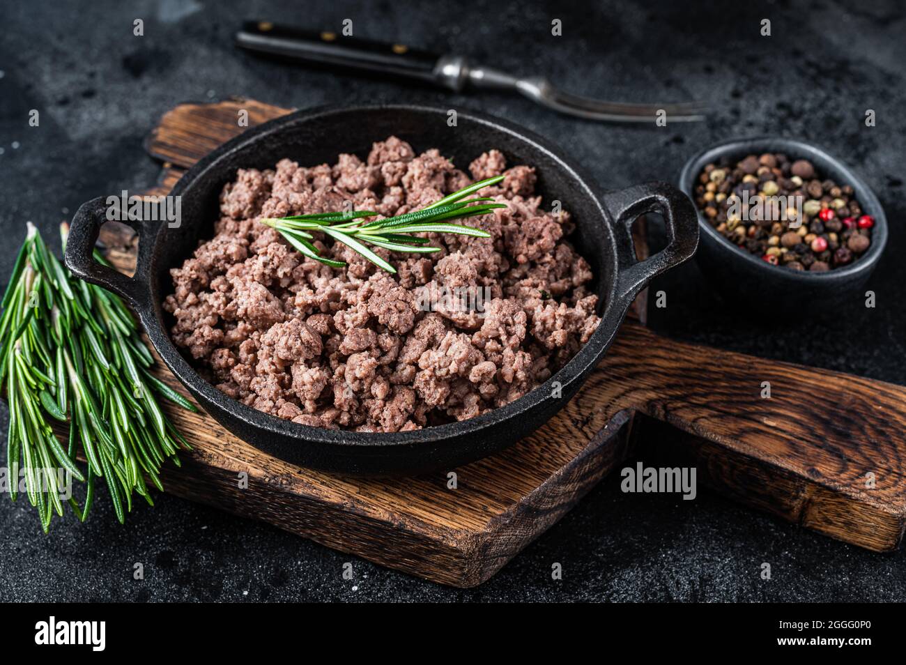 Fried mince beef meat in a pan for cooking pasta. Black background. Top ...