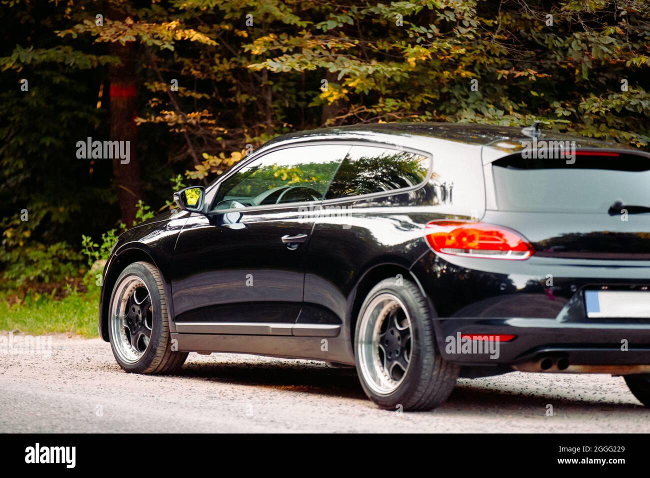 Back side view photo of a luxury black glossy automobile with cool ...