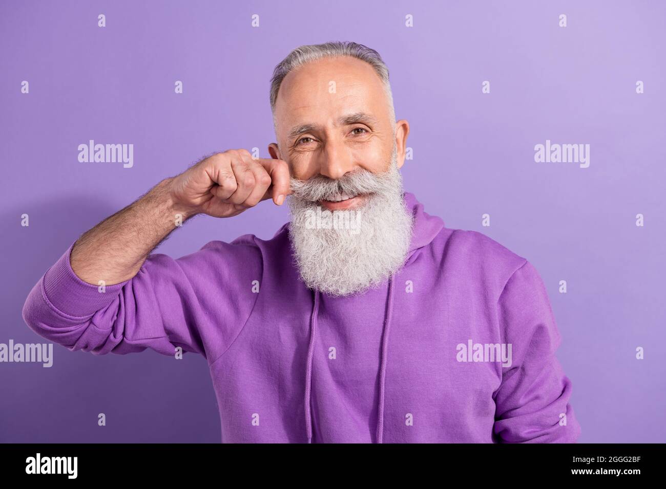 Portrait of attractive groomed cheerful grey-haired man touching fixing ...