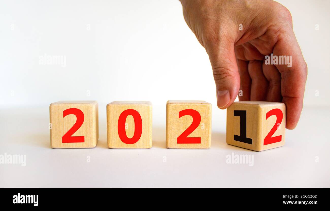 2022 happy new year symbol. Businessman turns a cube, symbolize the ...