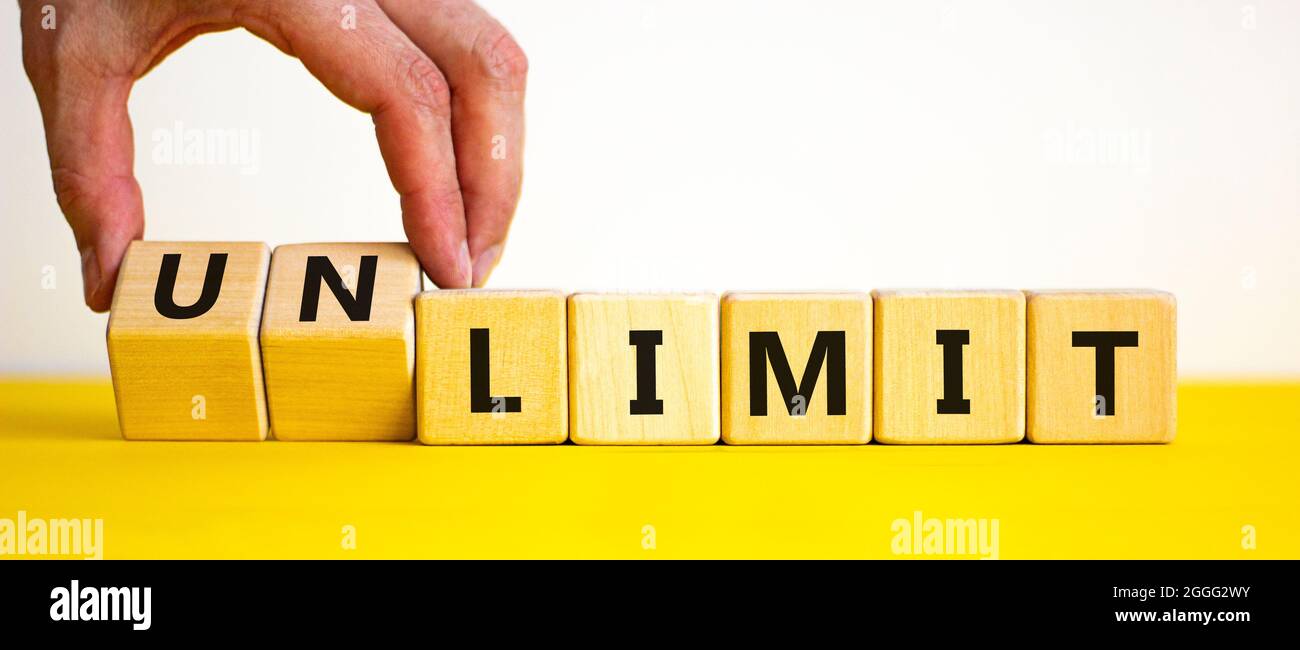 Limit or unlimit symbol. Businessman turns cubes, changes words 'limit ...