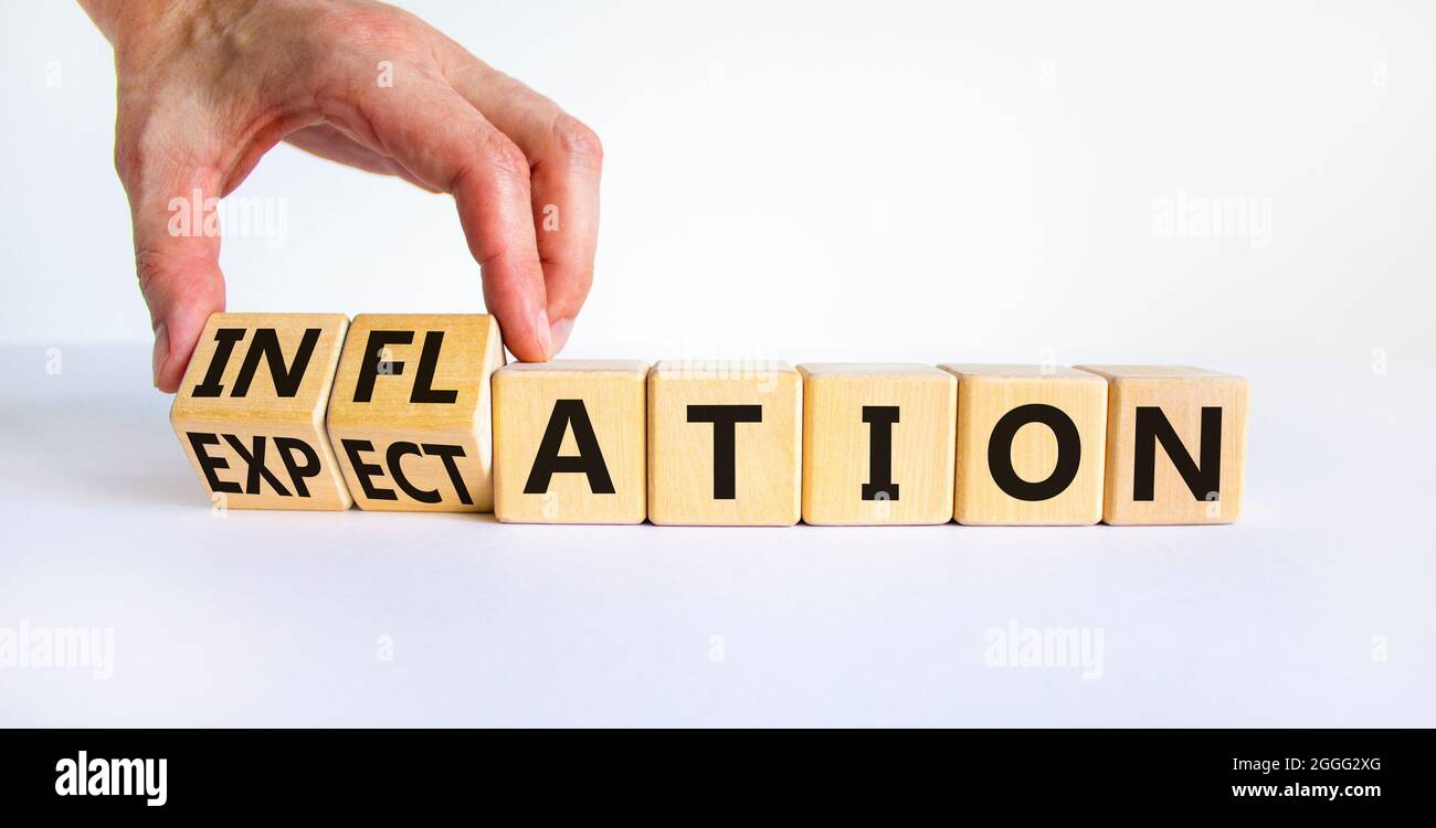 Inflation and expectation symbol. Businessman turns cubes, changes the ...
