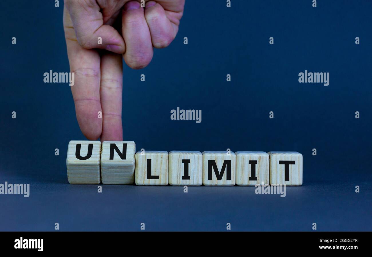 Limit or unlimit symbol. Businessman turns cubes, changes words 'limit ...
