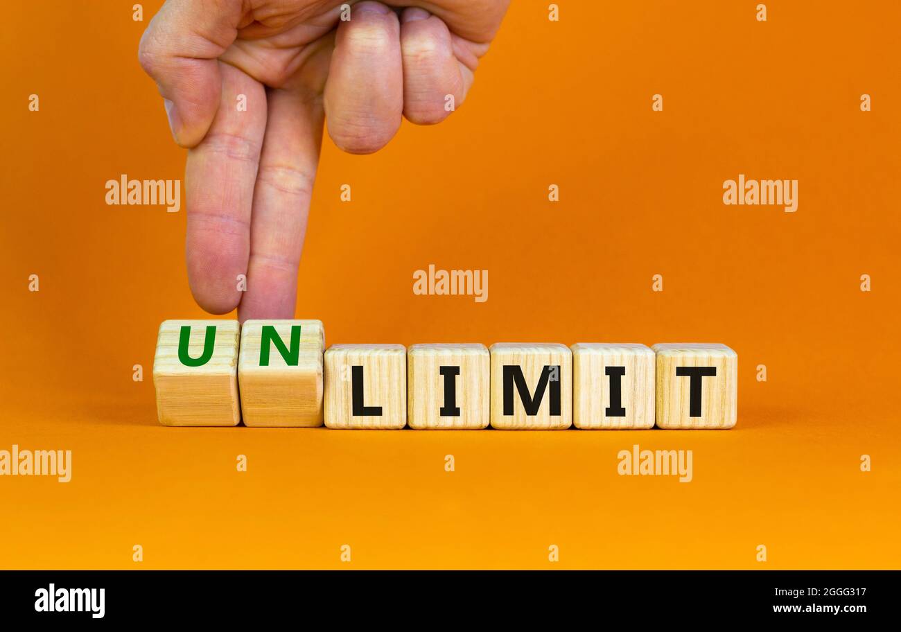 Limit or unlimit symbol. Businessman turns cubes, changes words 'limit ...