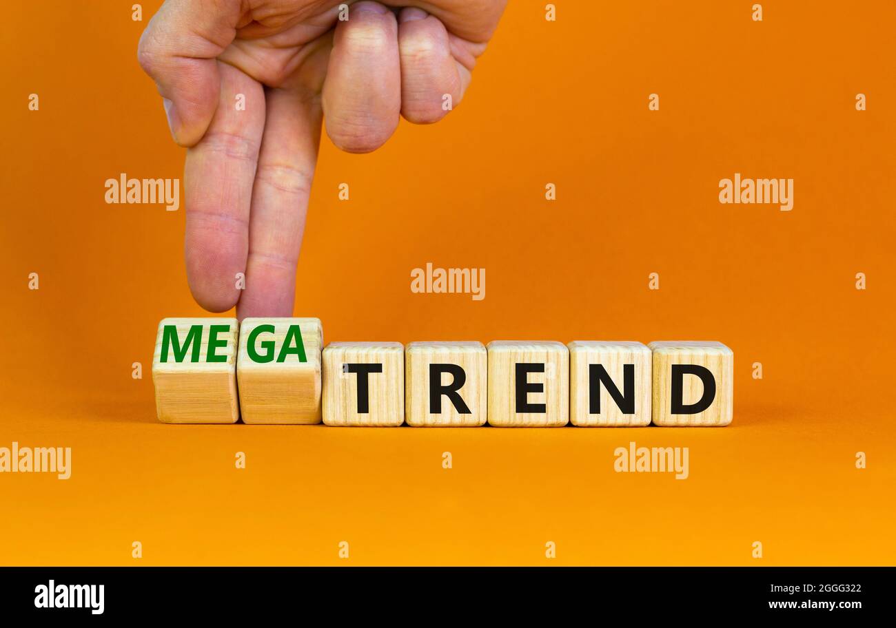Trend or megatrend symbol. Businessman turns wooden cubes and changes ...
