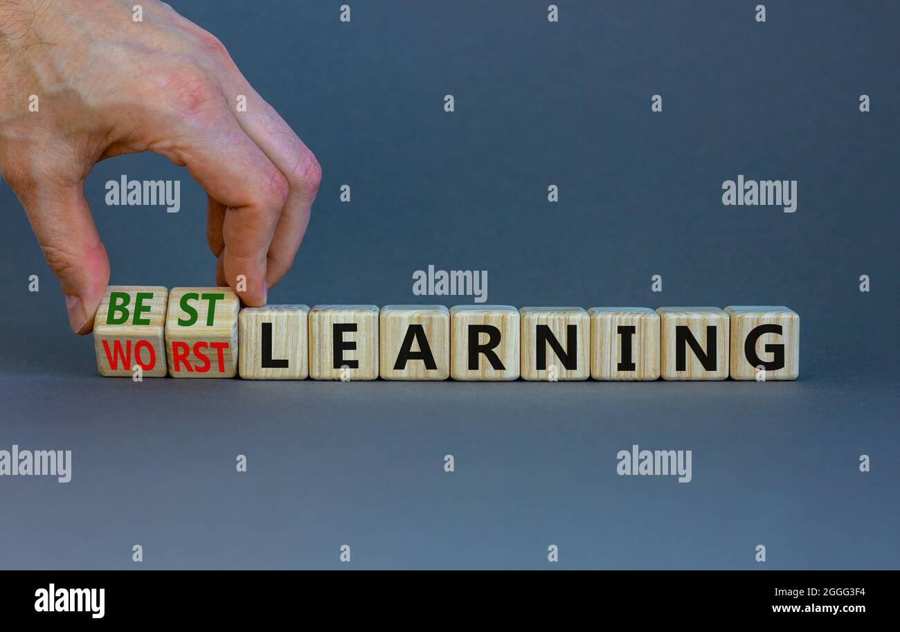 Best or worst learning symbol. Businessman turns cubes, changes words ...
