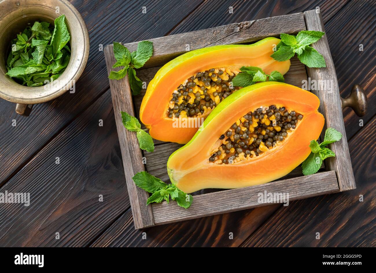 Papaya in the wooden box: cross section Stock Photo - Alamy
