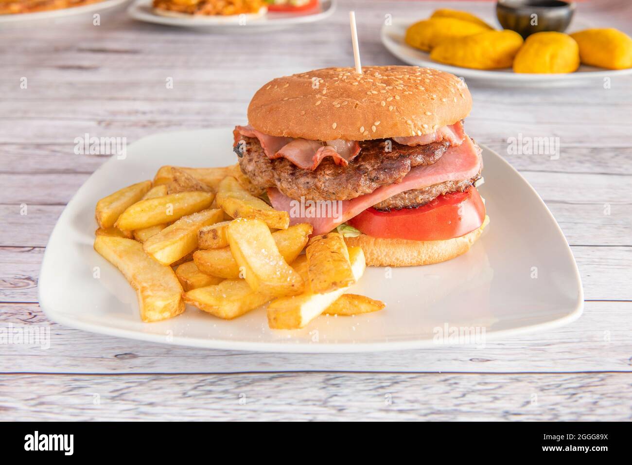 Classic hamburger with two meats, ham, bank, sliced tomato and French ...