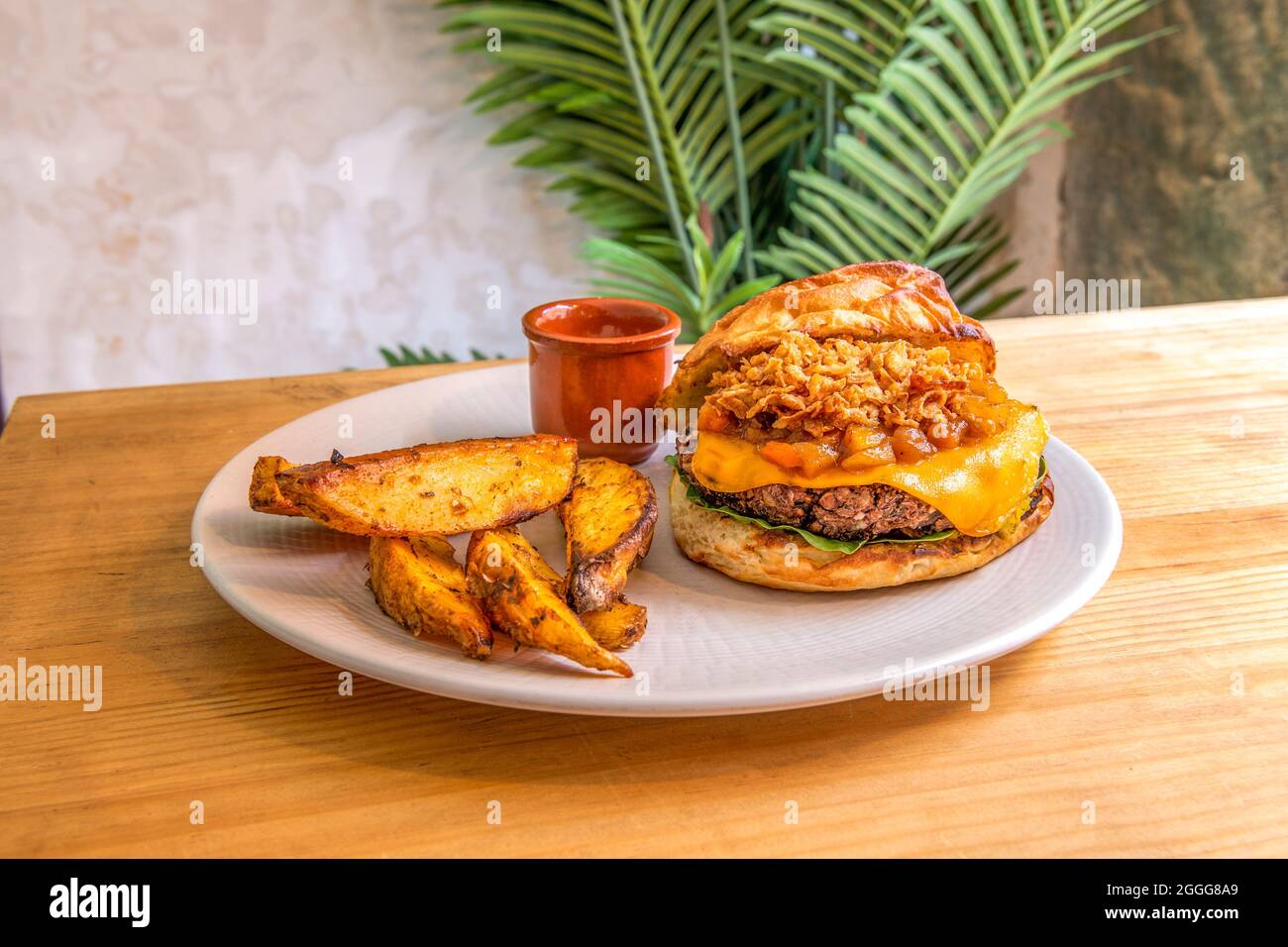 Wild beef burger with melted cheddar cheese, lettuce, crispy onion and ...