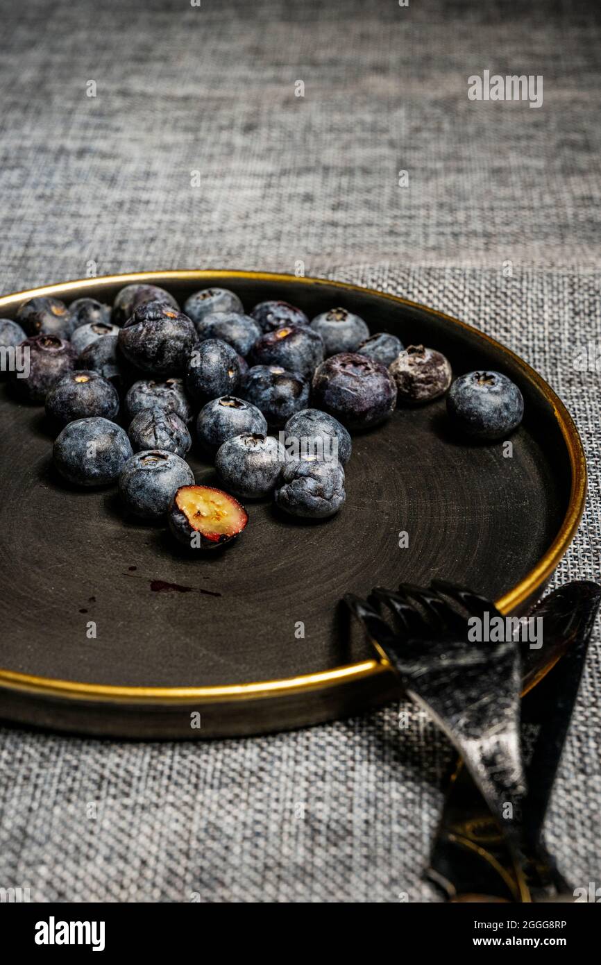 Image with focus on the well-ripe blueberries that are inside a black ...