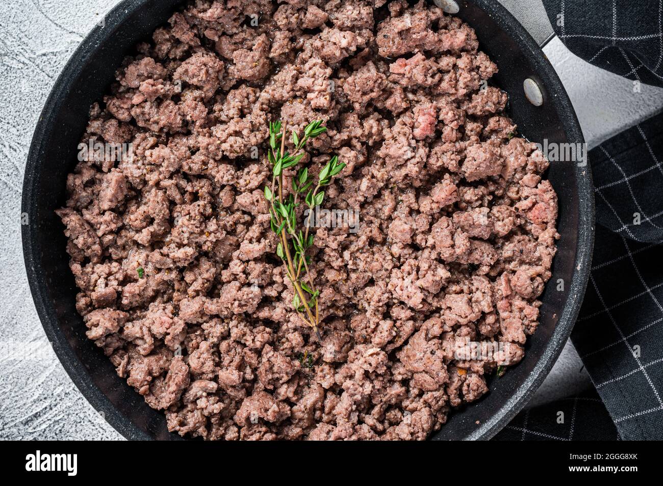 Fried ground mince beef and pork meat in a pan with herbs. White ...