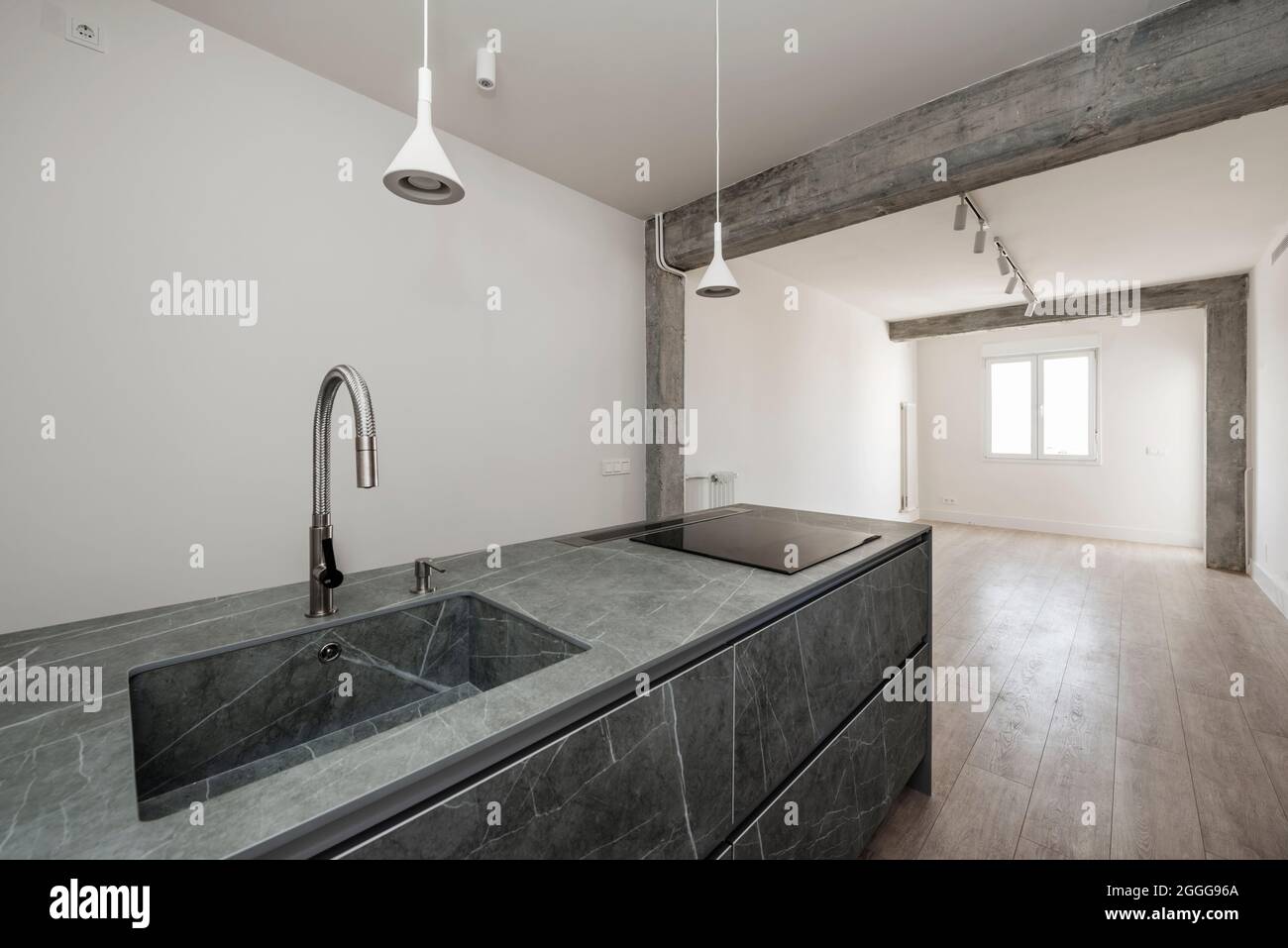 Kitchen island with sink and ceramic hob in kitchen with exposed ...