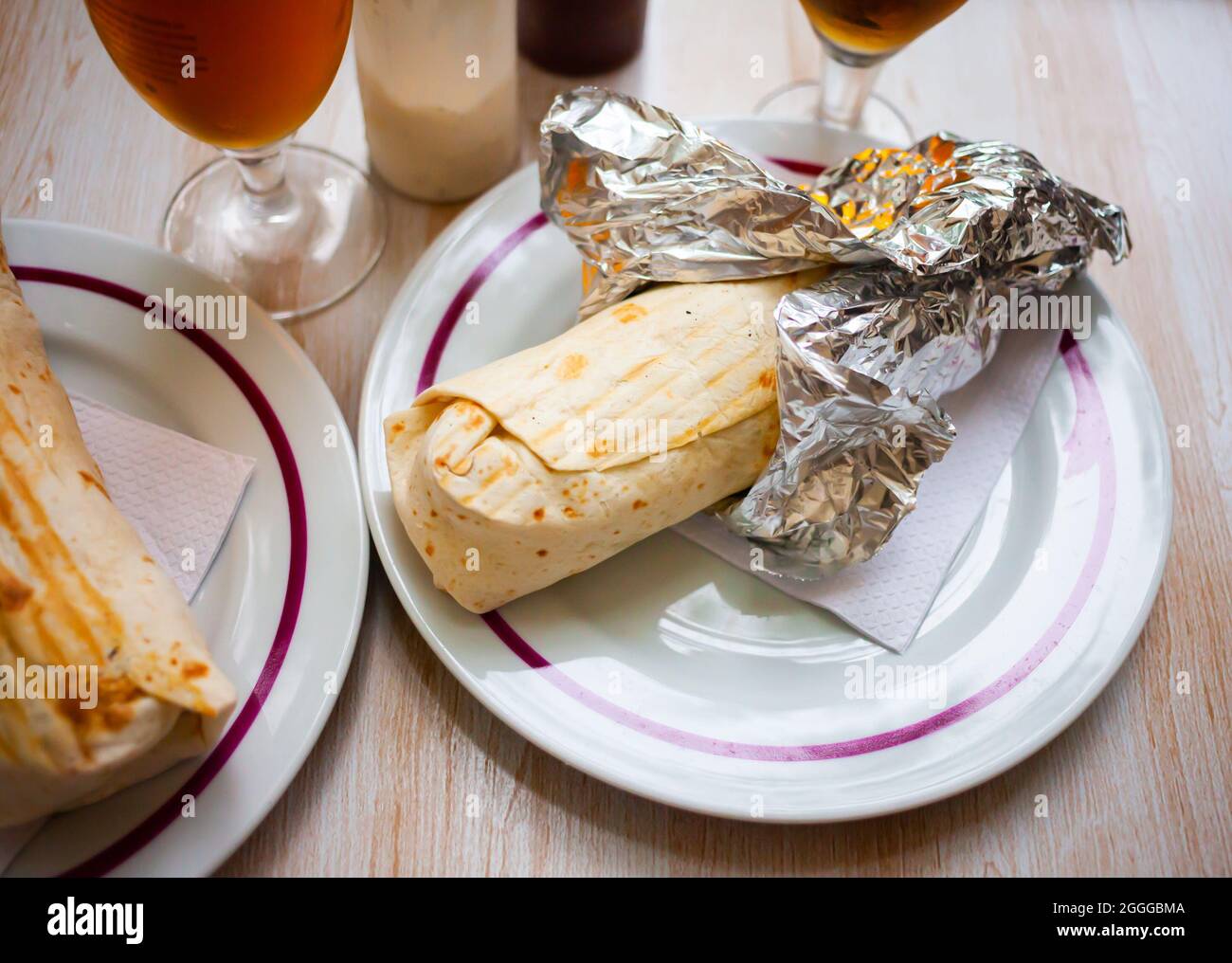 Turkish wrapped dish durum on white plate Stock Photo - Alamy