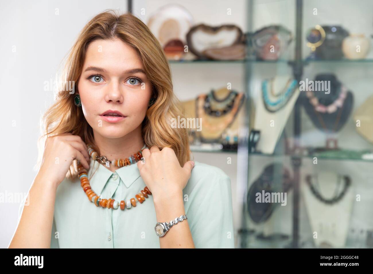 Female client trying on natural gemstone beads Stock Photo - Alamy