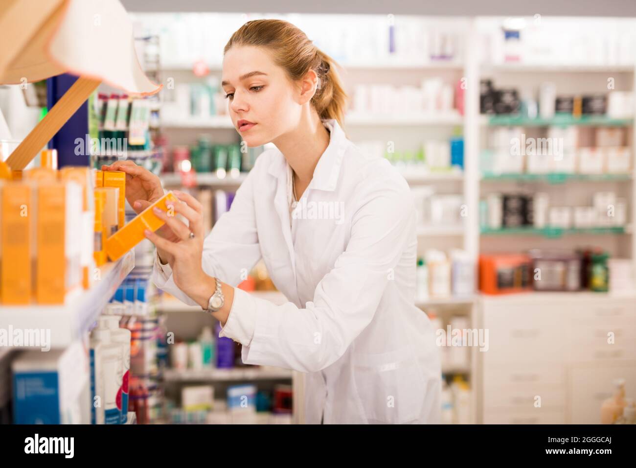 Female pharmacist arranging medicines Stock Photo - Alamy