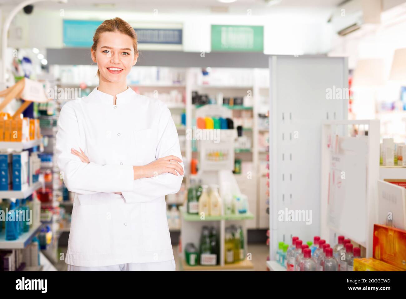 Portrait of young positive female pharmacist in modern drugstore Stock ...