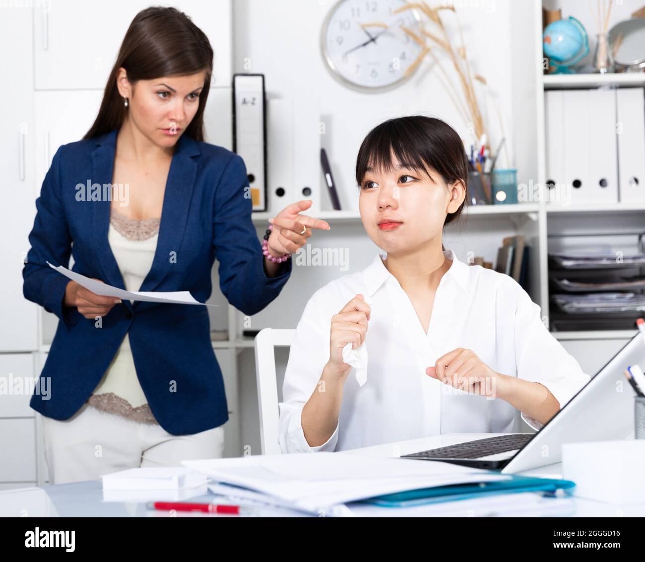 Angry boss screaming to young female manager during working Stock Photo ...